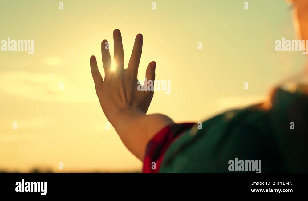 Happy teenage girl touches sun with her fingers. Child holds out his hand at Stock Video Footage ...