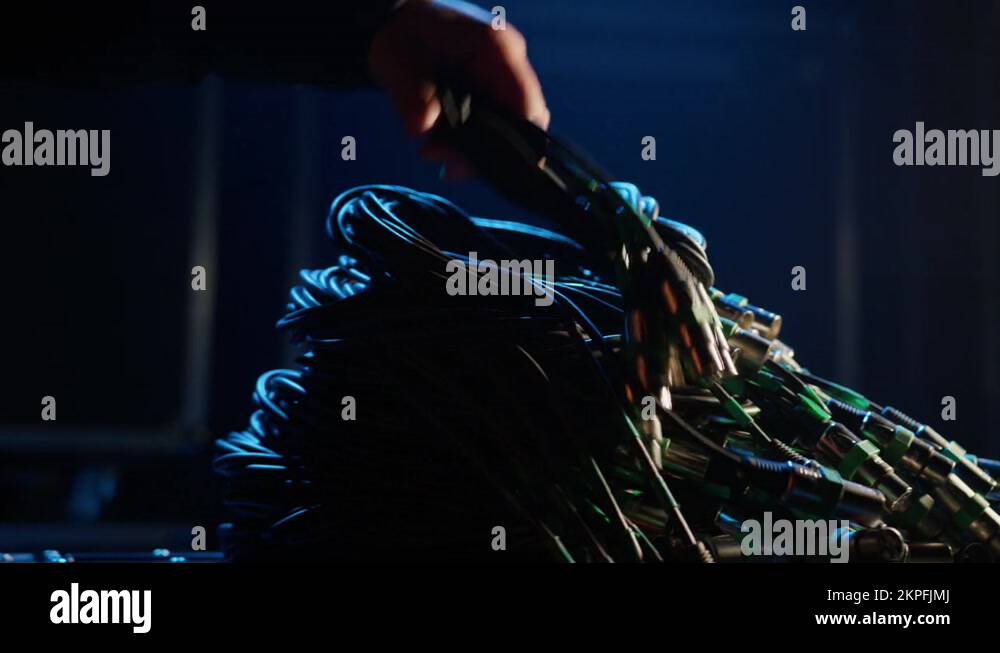 The man takes a bunch of XLR wires. Switching the stage before the ...
