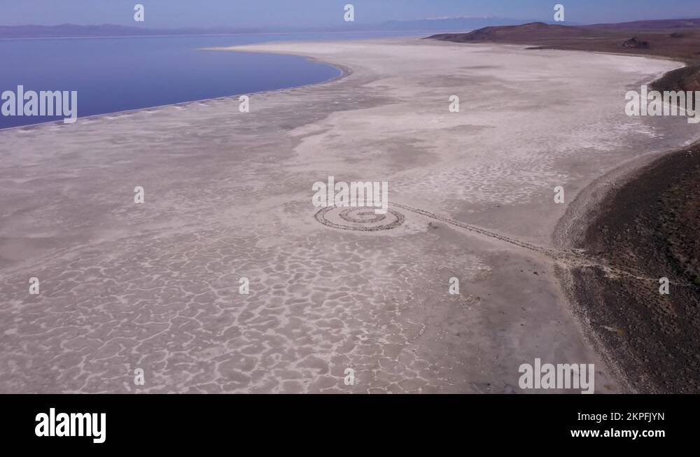 Spiral Jetty along Utah's Great Salt Lake, drone approach tilt down ...