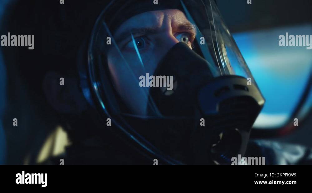 Military armed forces pilot with oxygen visor inside cockpit of fighter ...