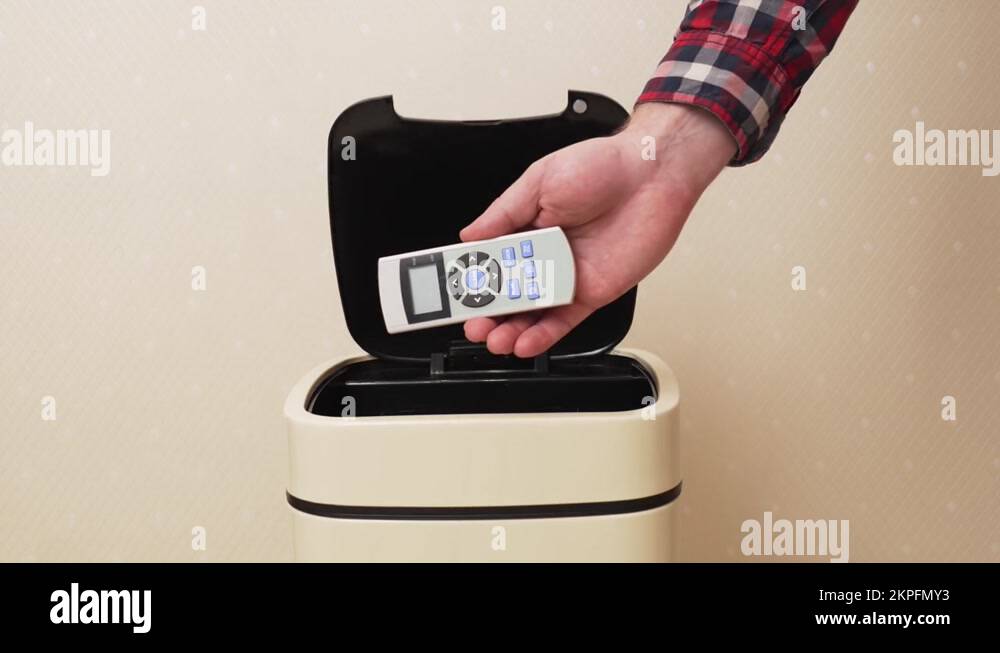 hand opens and throws the remote control into Sensory trash can Stock ...