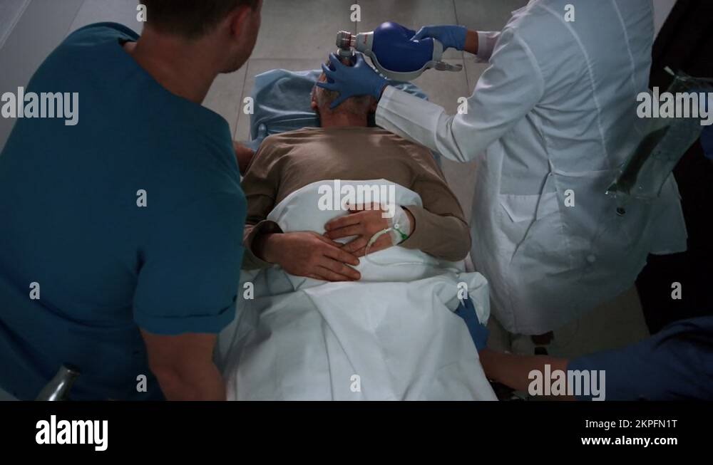 Medical workers carrying patient on gurney. Doctor hands using ...