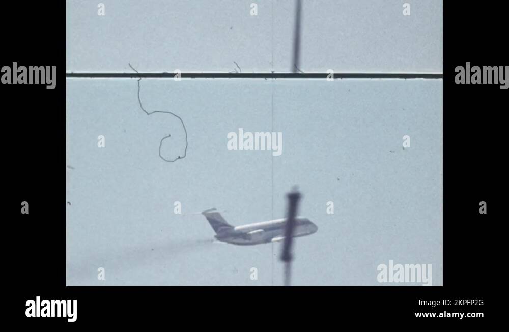 1960s: plane in sky, condensation trail behind plane, helicopter at ...