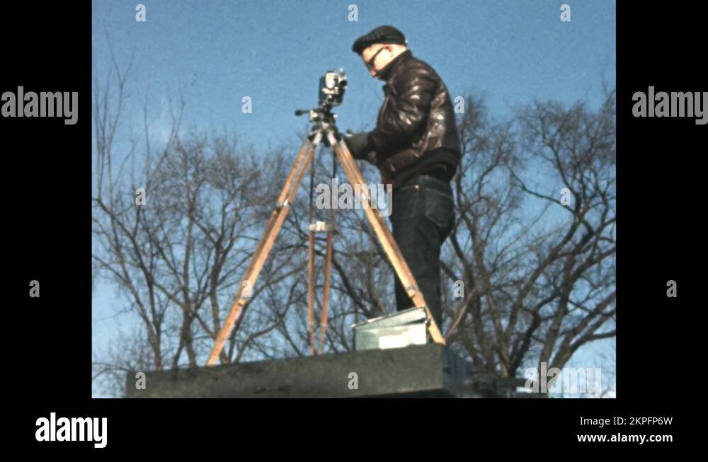 1950s: Men in American Football scrum. Man sets us cine camera on ...