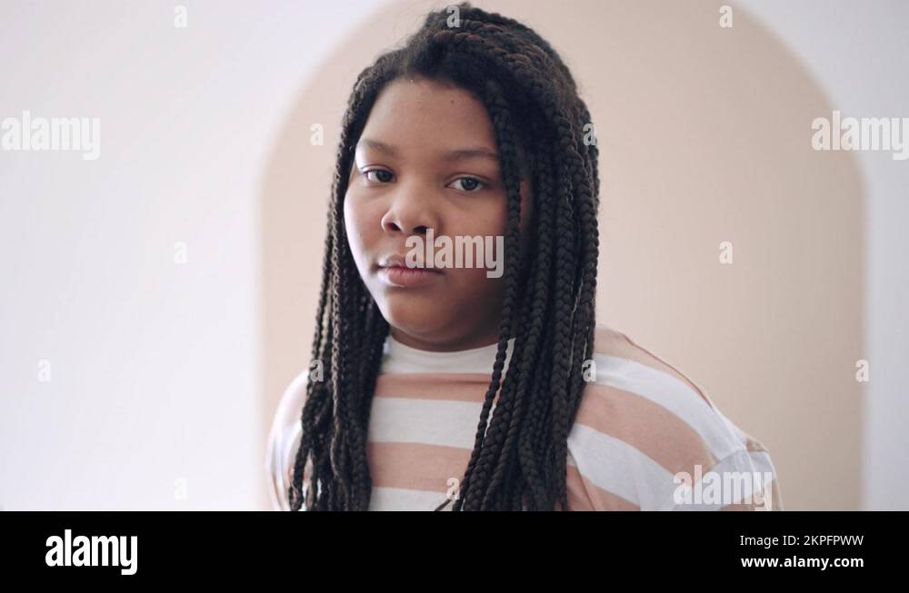 Angry and upset black teenage girl stares at camera with fuming ...
