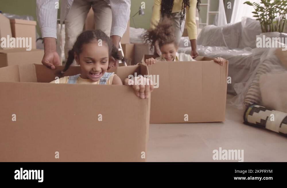 Two Girls Riding in Cardboard Boxes on Moving Day Stock Video Footage ...
