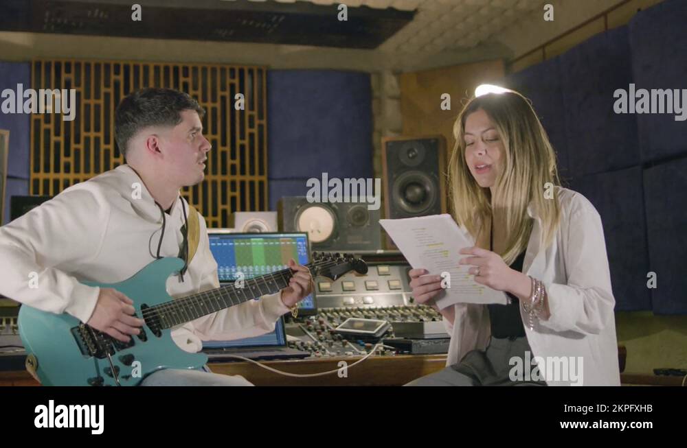 Two musicians working in music studio while recording new song Stock ...