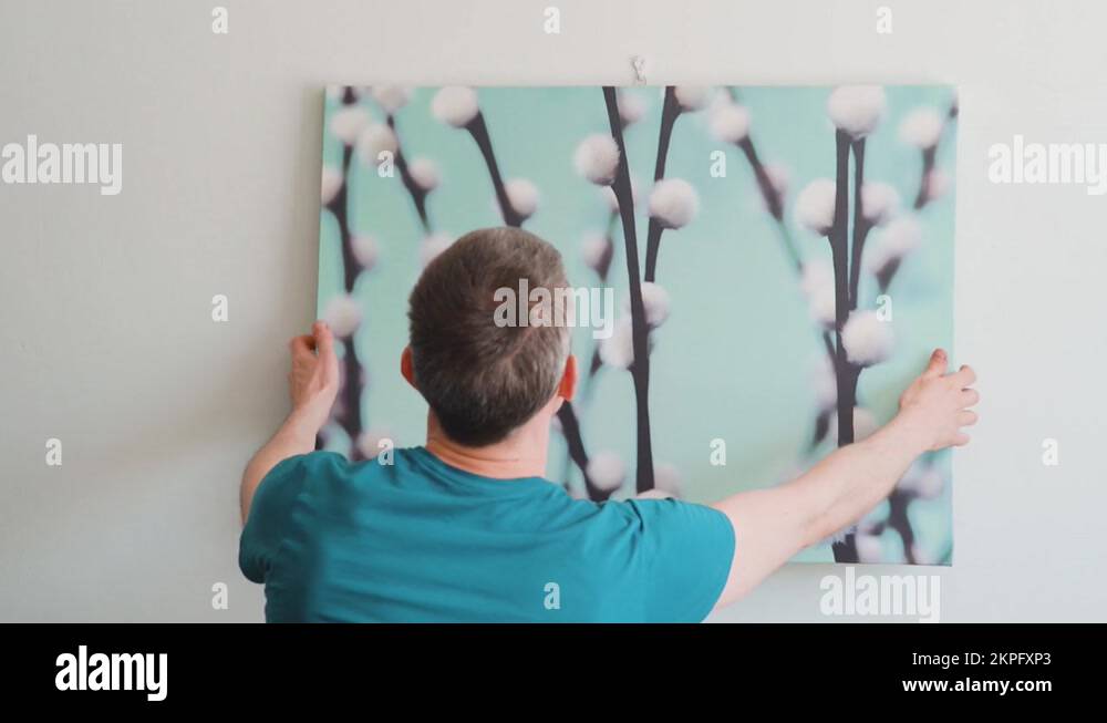 Man taking off a picture from the wall Stock Video Footage - Alamy