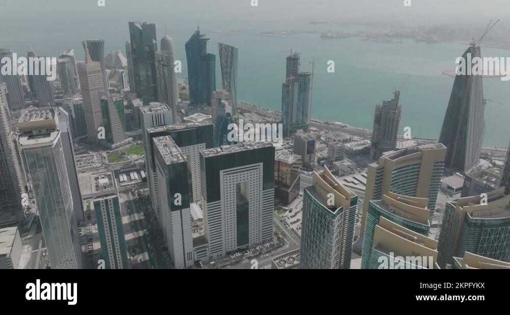 Doha, Qatar. Rotating drone shot over high-rise buildings and towers at ...
