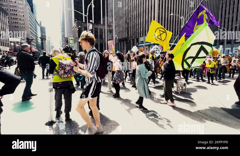 Large crowd of people walking by during an Extinction Rebellion protest ...