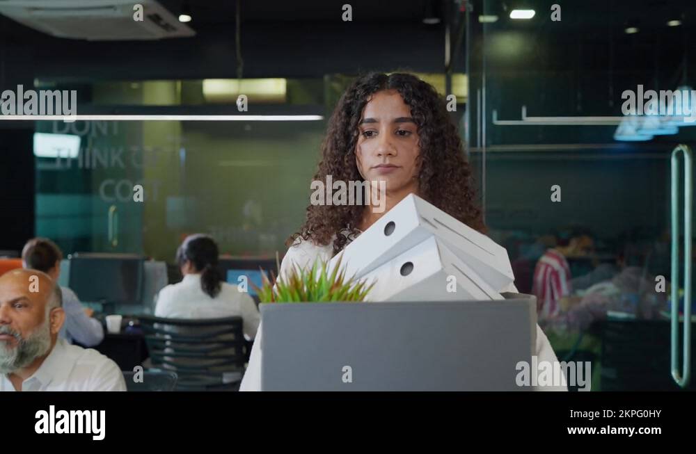 Sad Indian corporate woman employee leaving the office after losing the ...