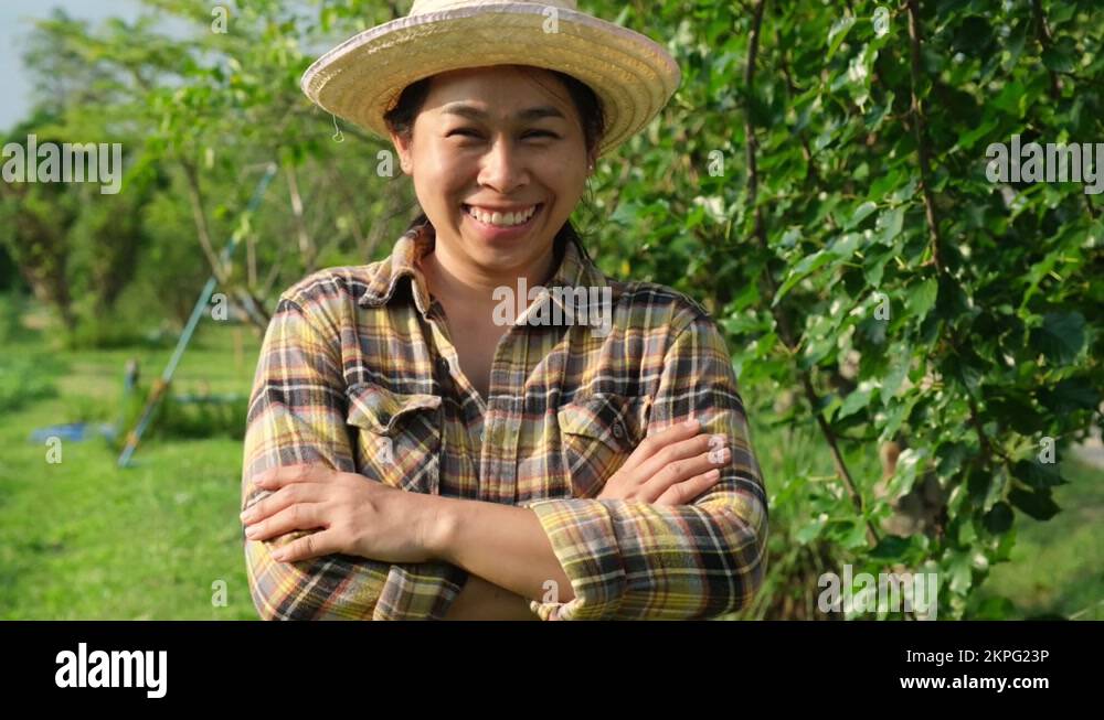 Successful female plantation owners stand in organic orchards for ...