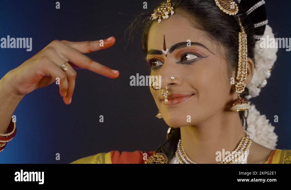 Close up head shot of bharatanatyam dancer doing eye moments or drishti ...