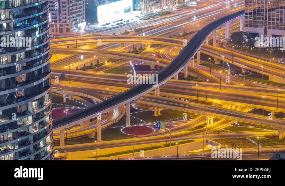 Highway intersection and overpass of Dubai downtown aerial night ...