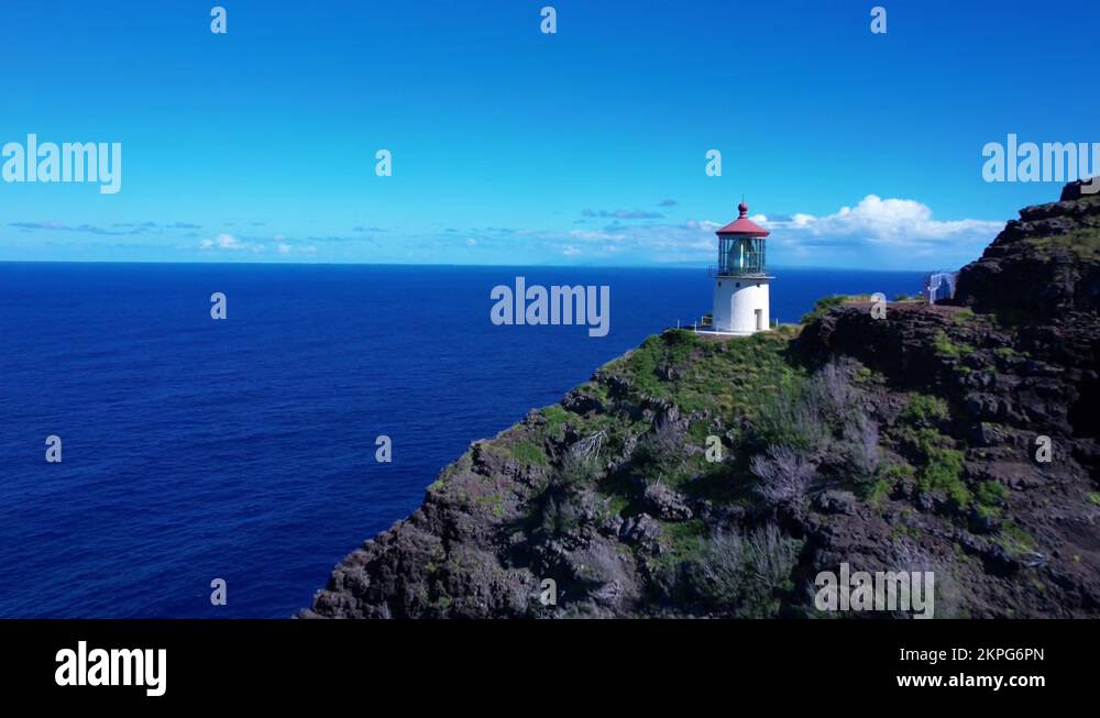 Flying past a Lighthouse on a Hawaiian cliff into the deep blue Pacific ...