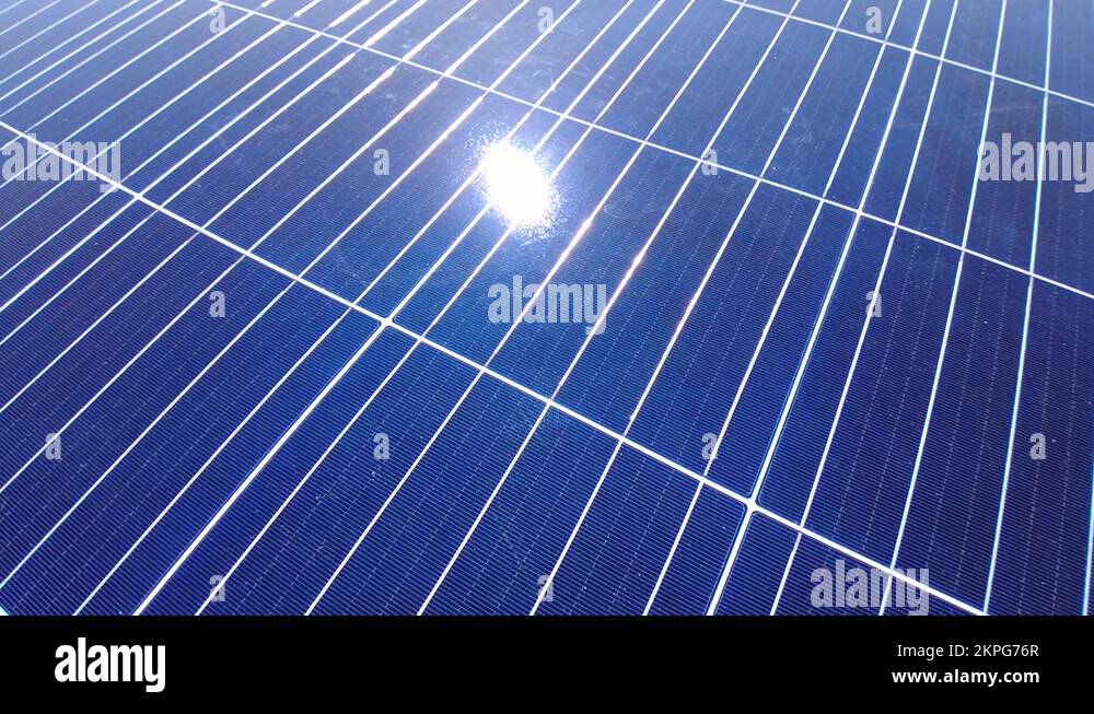 Rotational aerial view over solar panels getting charged under direct ...