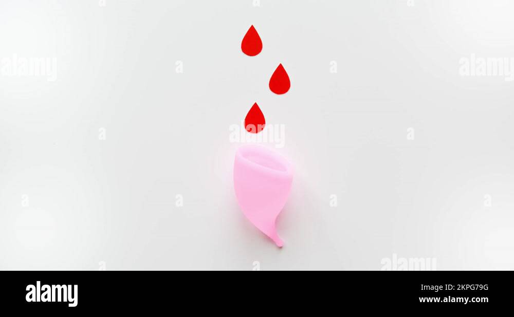 Drops of blood cut out of paper drip into the menstrual cup Stock Video Footage - Alamy