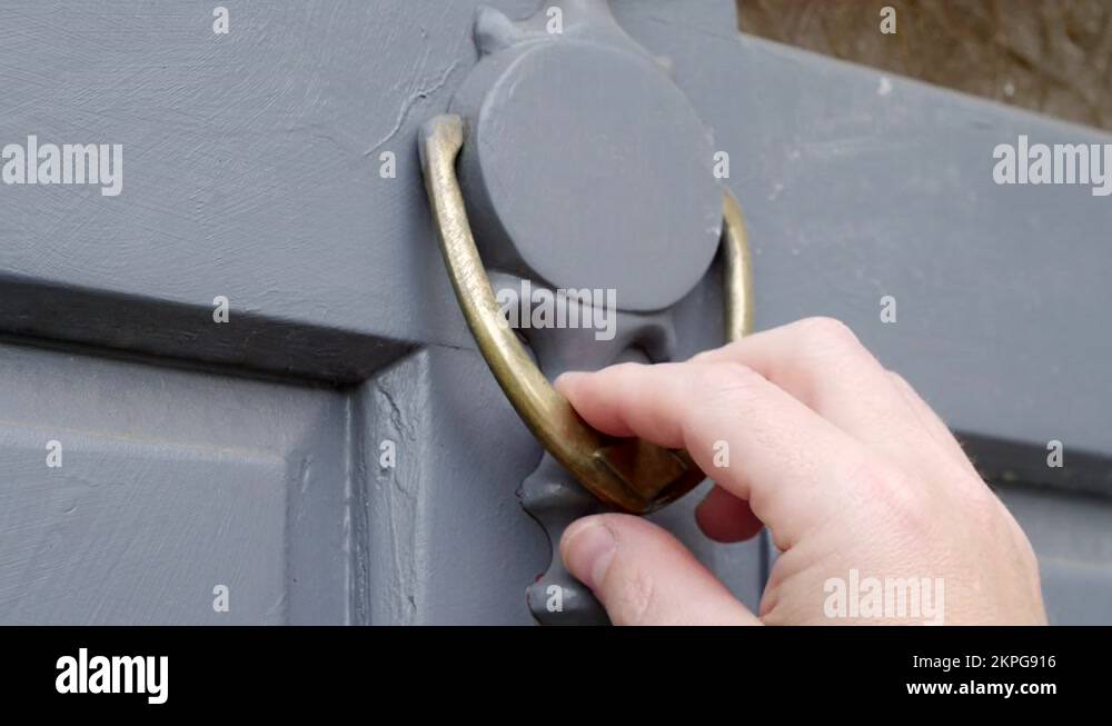 Close up of a man using a door knocker to knock on a door Stock Video ...