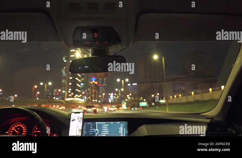 Car driving on Dubai Marina street at night. Inside car view driving in ...