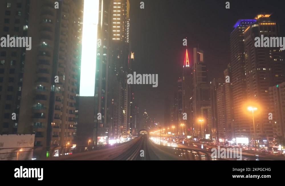 Subway metro train rides among the glass skyline building in Dubai UAE ...