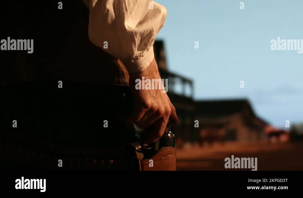 Cowboy preparing to draw his gun during standoff, CU on hands and ...