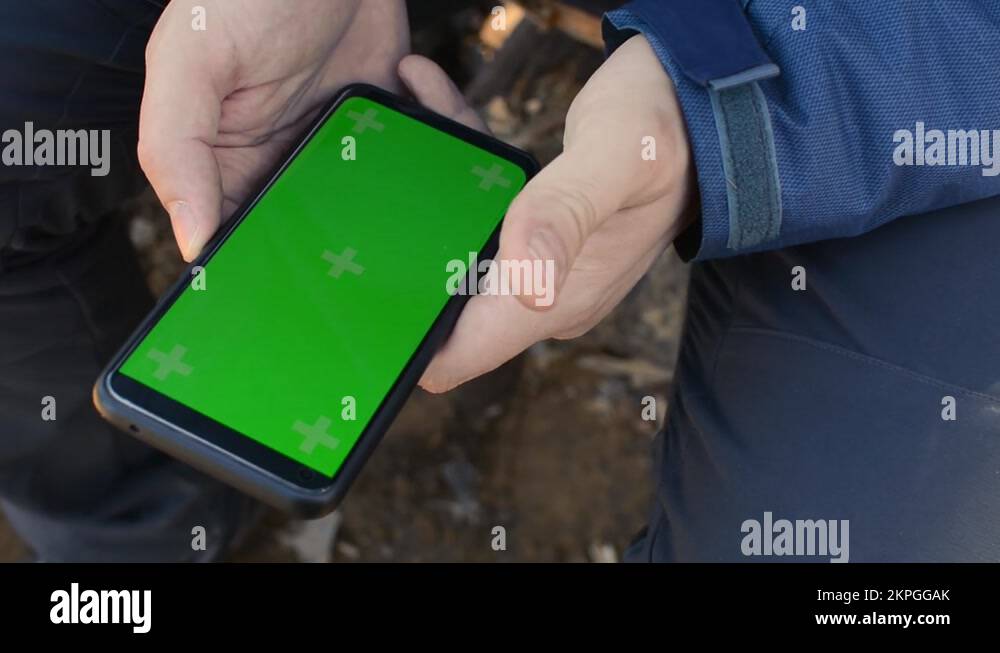 Man hand holding a smartphone touching phone with vertical green screen Stock Video Footage - Alamy