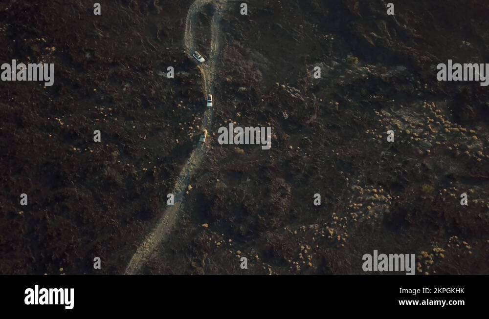 Convoy of 3 jeeps driving over lava field, Erta Ale volcano, Ethiopia ...