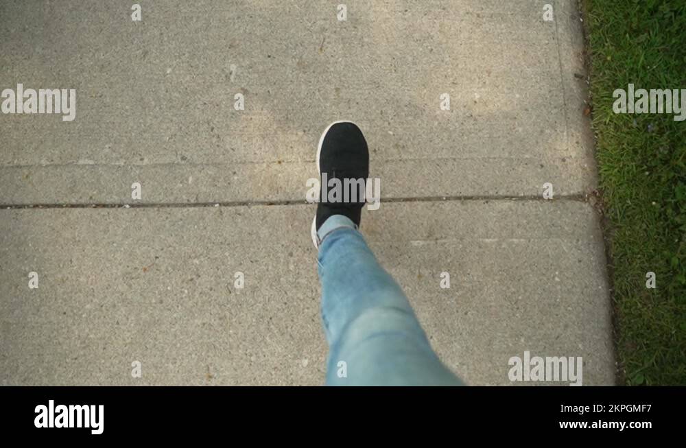 Point of View. Looking down at feet walking on cement sidewalk. Super ...