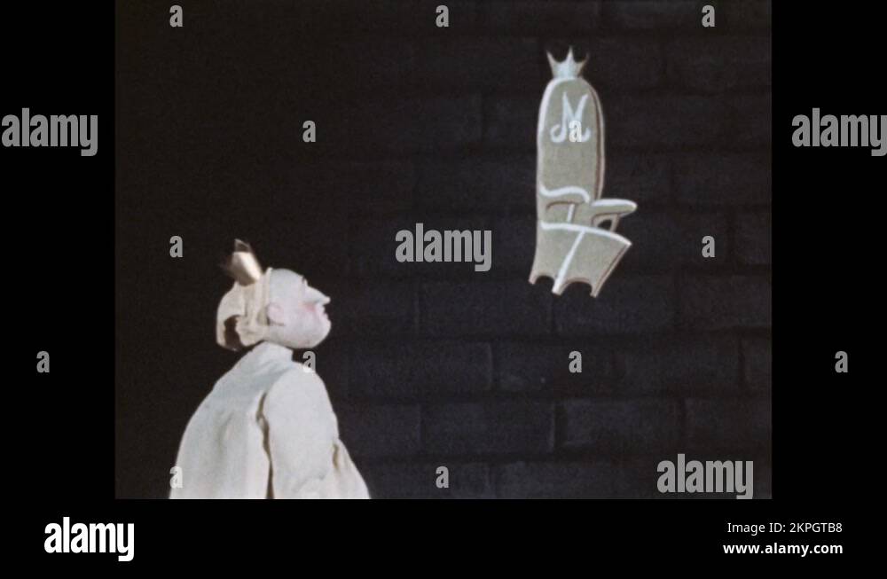 1950s: Large metal man puppet nods. Puppet king imagines various gold ...