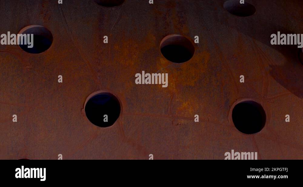 Holes in a metal blank, rusty metal. Industrial detail in a factory ...