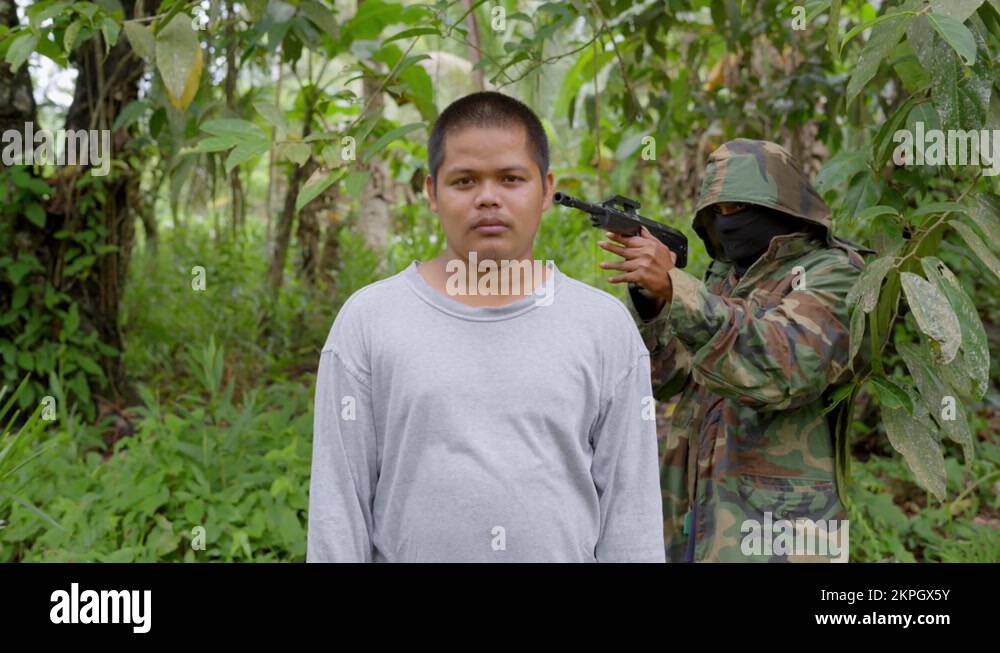 Terrorist In Military Suit Pointing A Gun On An Innocent Man In The ...