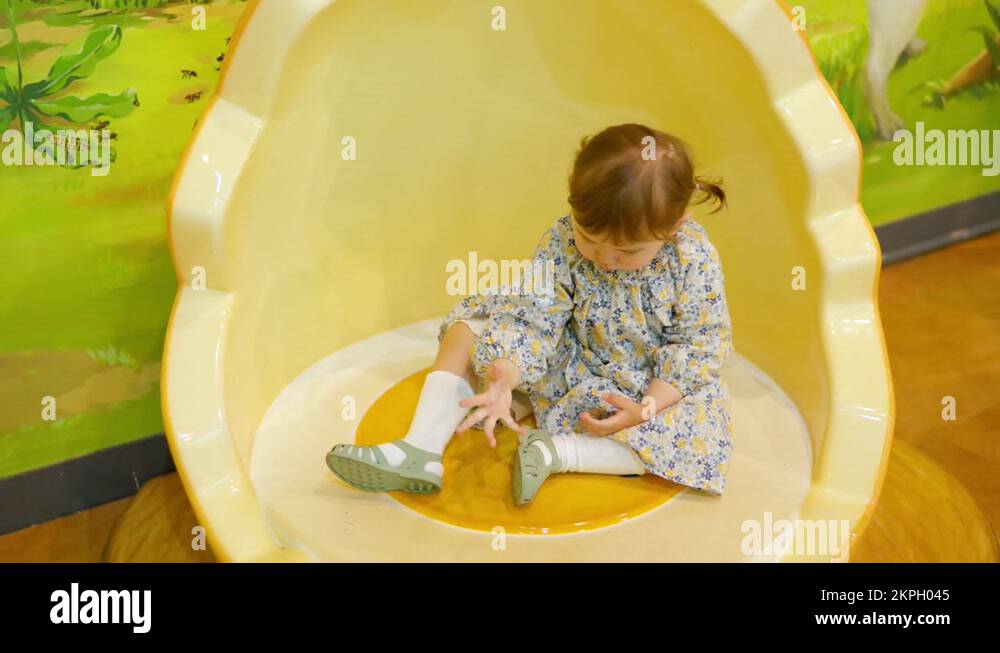 Cute And Pretty Little Girl Sitting On Cracked Egg Shell-like Chair At ...