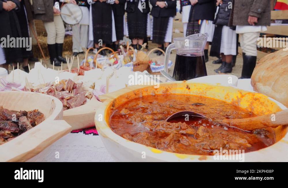 Wooden pots and plates with homemade traditional food and traditionally ...