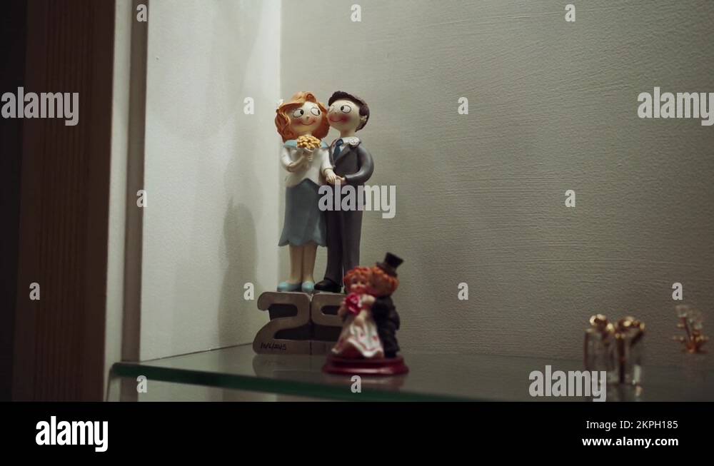 Ceramic figure on a glass shelf of a couple that have been married for ...