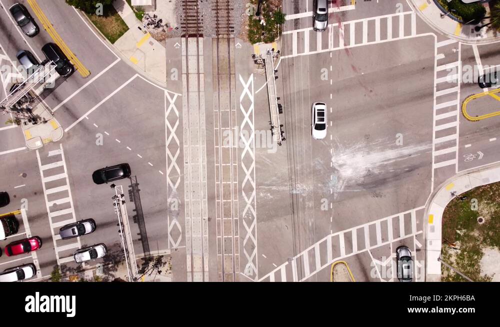 City intersection with railroad tracks Stock Video Footage - Alamy