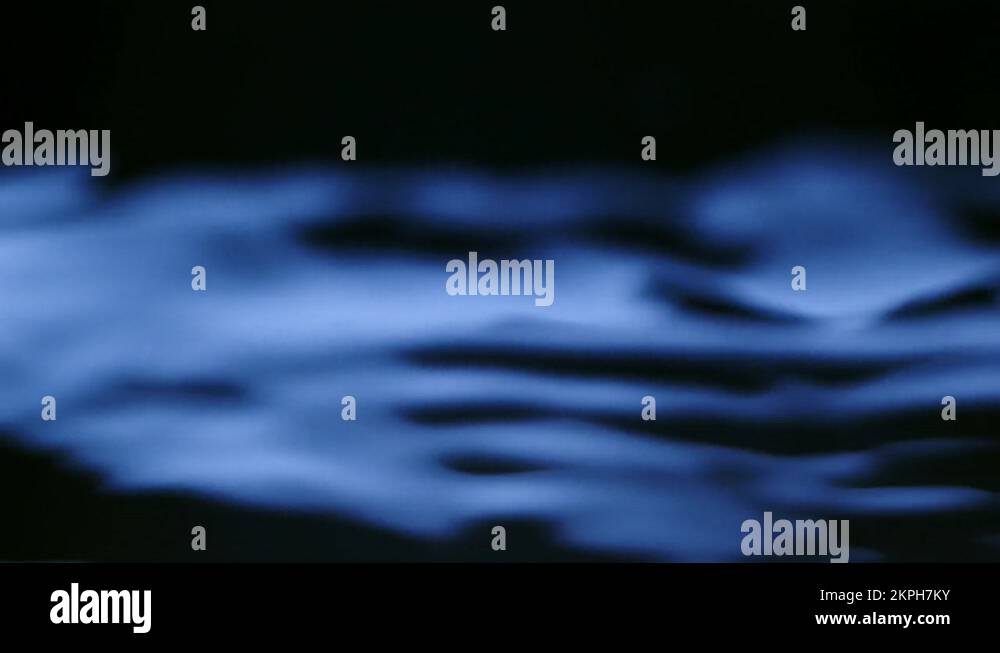 Real of water drop falls into water and diverging circles of water with ...