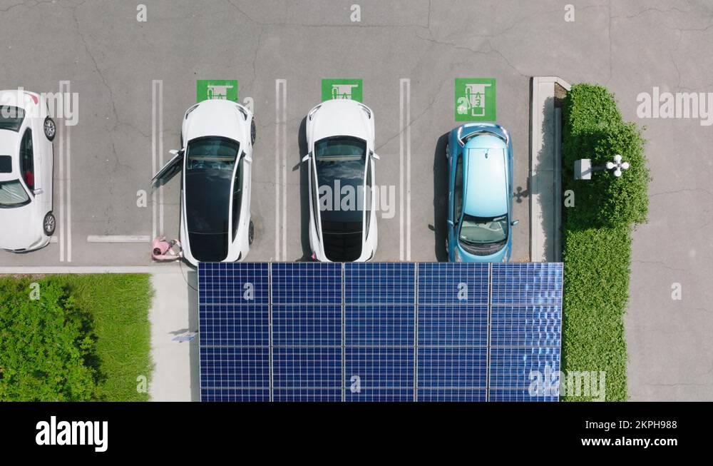 Modern electric car at renewable power solar batteries charging station ...
