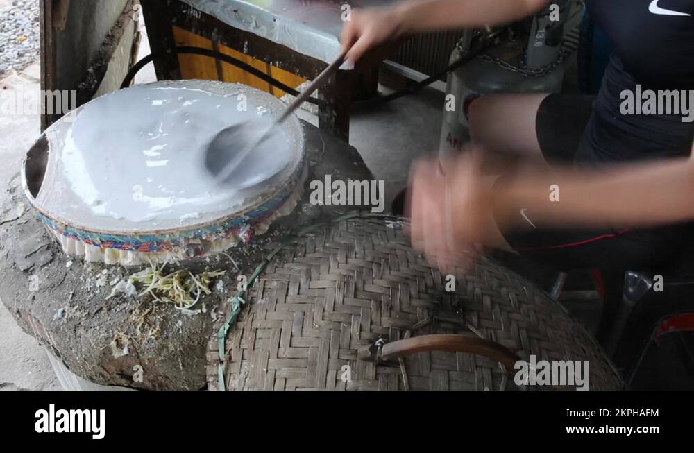 Making steamed rice noodle sheets (banh uot, bánh cuốn), traditional ...