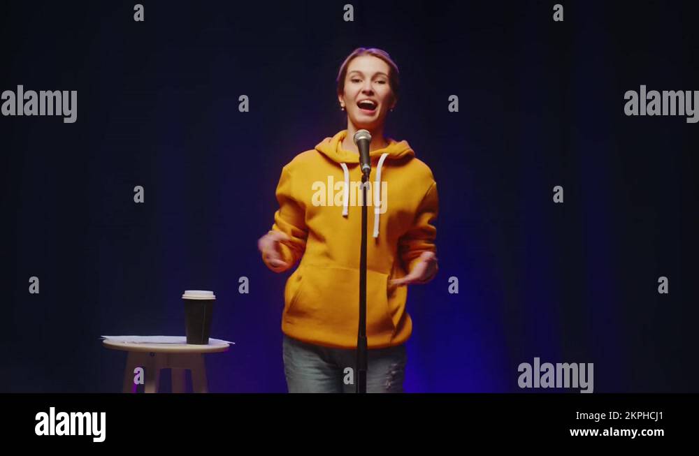 Stand-up cafe, woman comedy concert. Woman telling jokes on stage ...