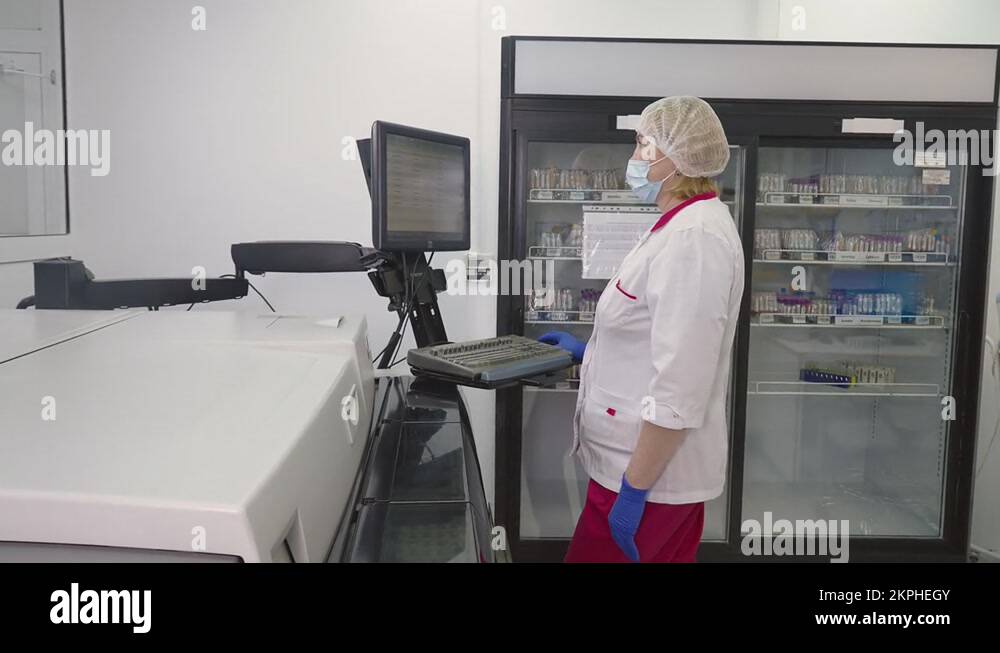 Female Doctor reading blood test results from the modern lab computer ...
