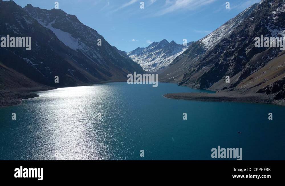 Boom up aerial view of Laguna del Inca, Chile with snowcapped mountains ...