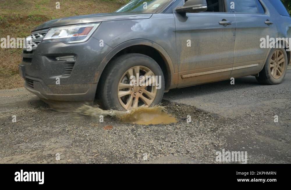 CLOSE UP: Tourist SUV drives into a massive pothole gaping in the ...