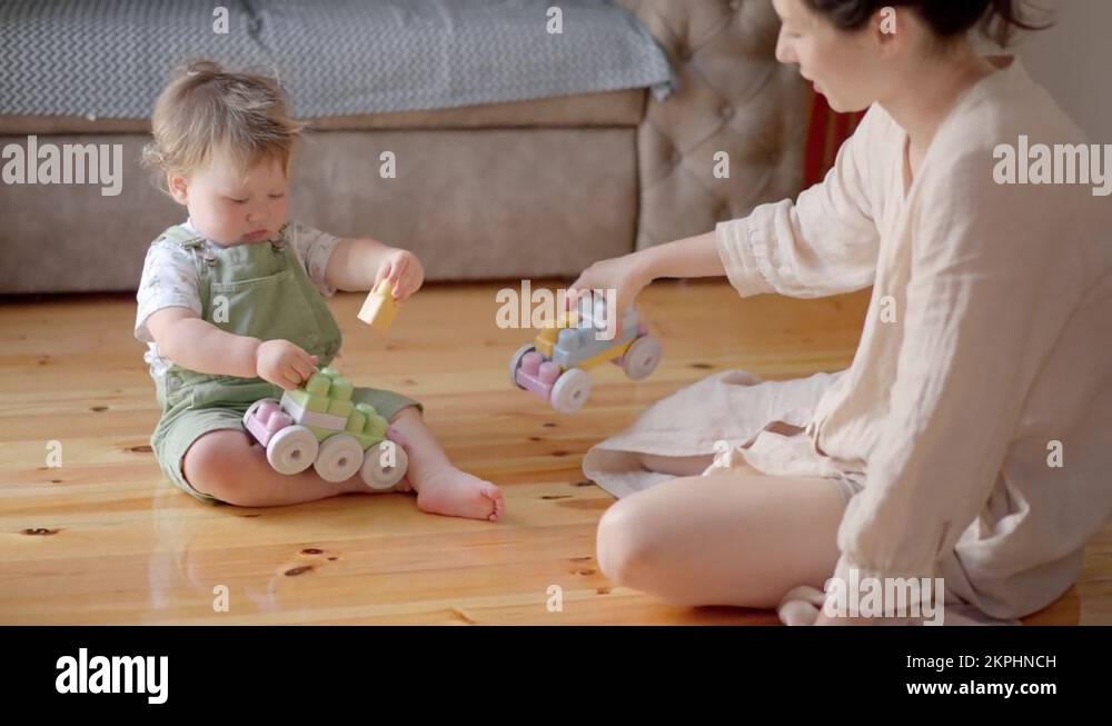 Happy cute family at home. Baby play with colored toys. Educational ...