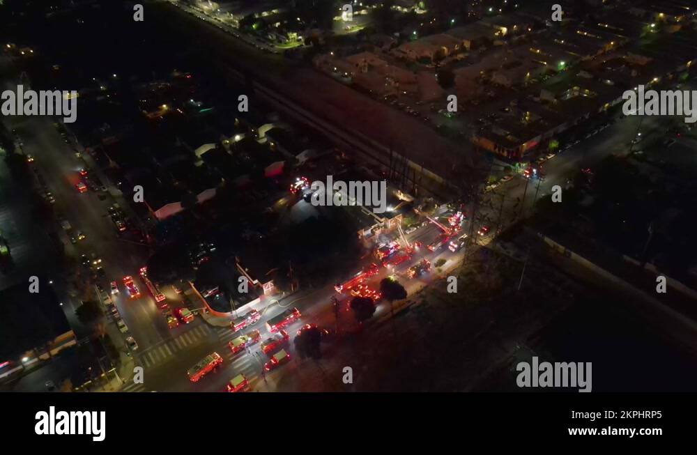 Firefighters, extinguishing a structure fire, during nighttime ...