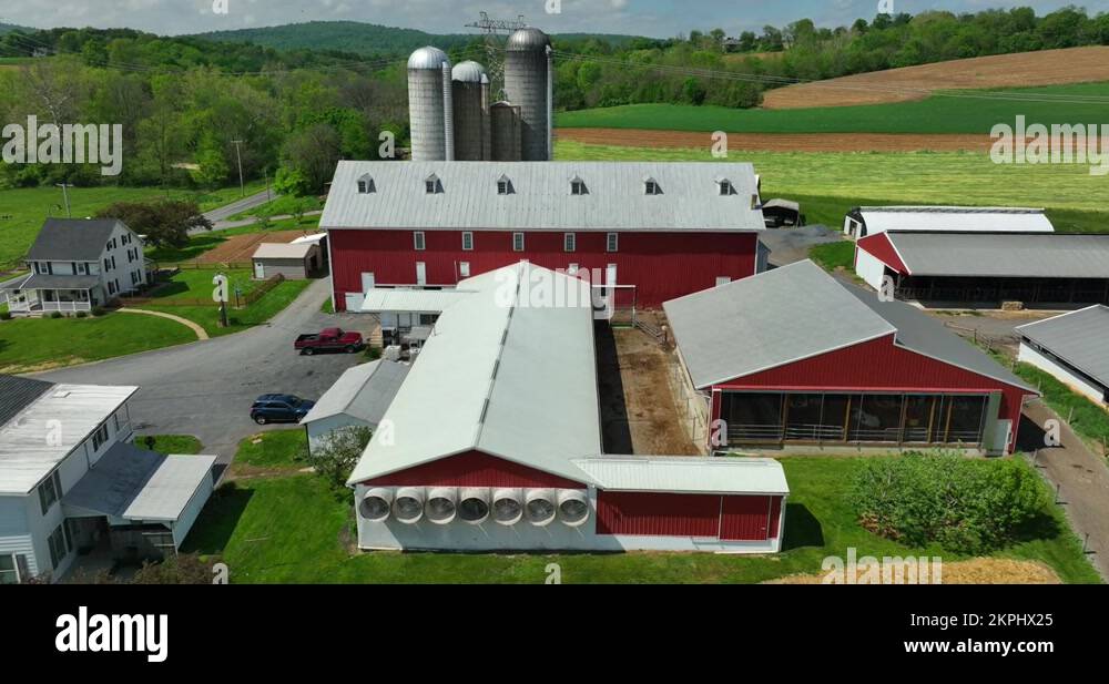 Large farm with multiple houses and barns. Aerial flyover with approach ...