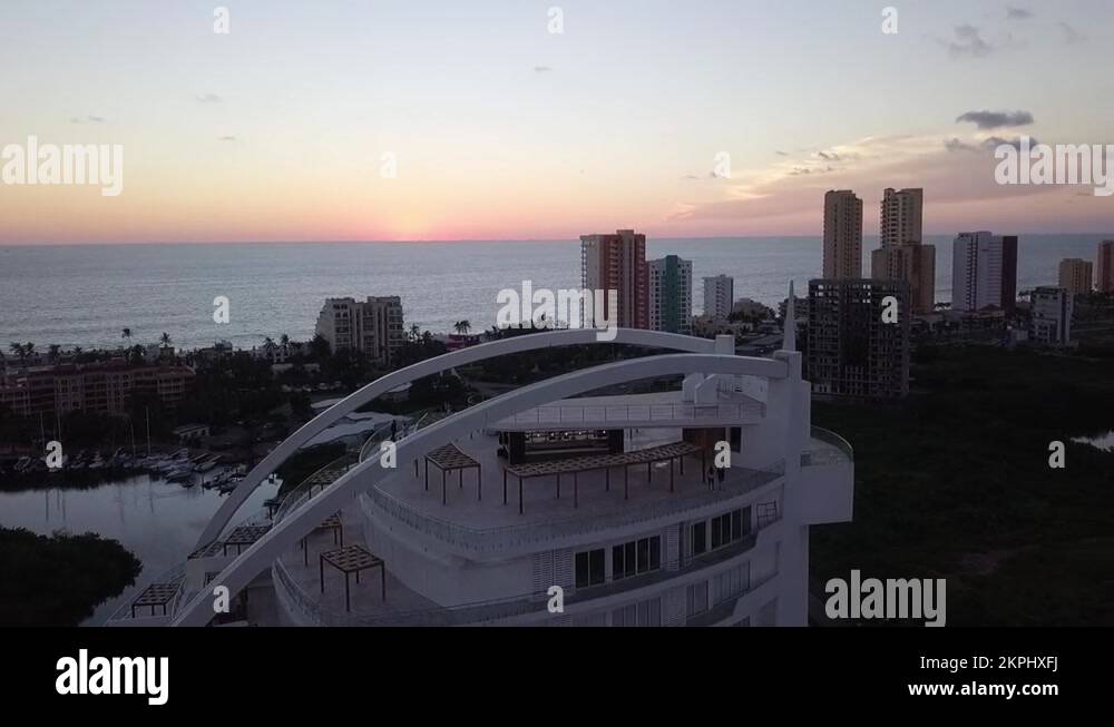 Aerial of rooftop Marina Platino luxury hotel, reveal of coastal resort ...