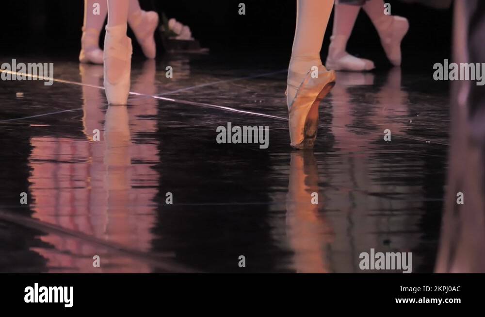 Slow motion vertical pan of ballet dancer's legs jumping and dancing on ...
