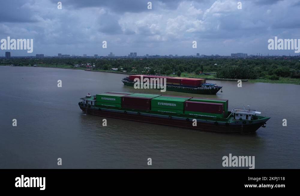 Large river boats carrying shipping containers on the Saigon River in ...