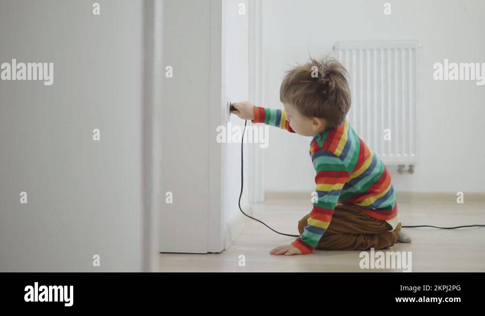Little kid insert the plug into the socket, risk of electric shock ...