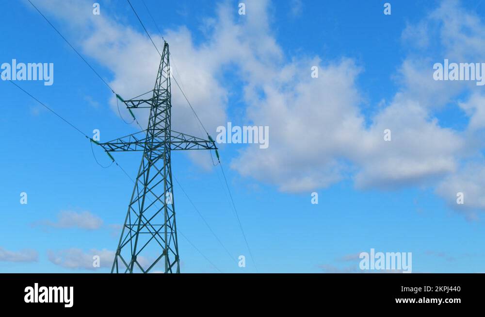 Electric line and electric wires with pylons in silhouette and blue sky ...